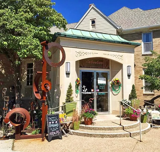Welcome to Skeleton Key, where time travel is just a doorknob turn away! This charming facade hints at the treasures within, complete with a rusty sculpture that's part modern art, part conversation starter.