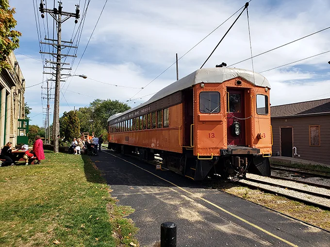 "All aboard the time machine!" This vibrant orange trolley isn't just a pretty face—it's your ticket to a bygone era of transportation magic.