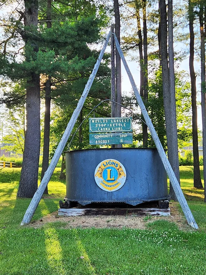 A soup-er sight to behold! This colossal kettle stands tall among the pines, ready to serve up a hearty dose of small-town charm.