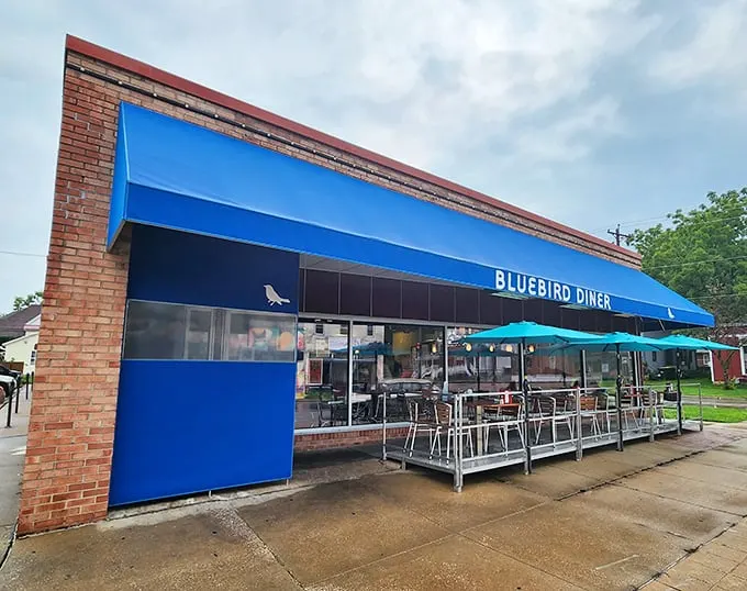 A blue beacon of breakfast bliss! The Bluebird Diner's cheery exterior promises comfort food that'll make your taste buds sing like Julie Andrews on a mountaintop.