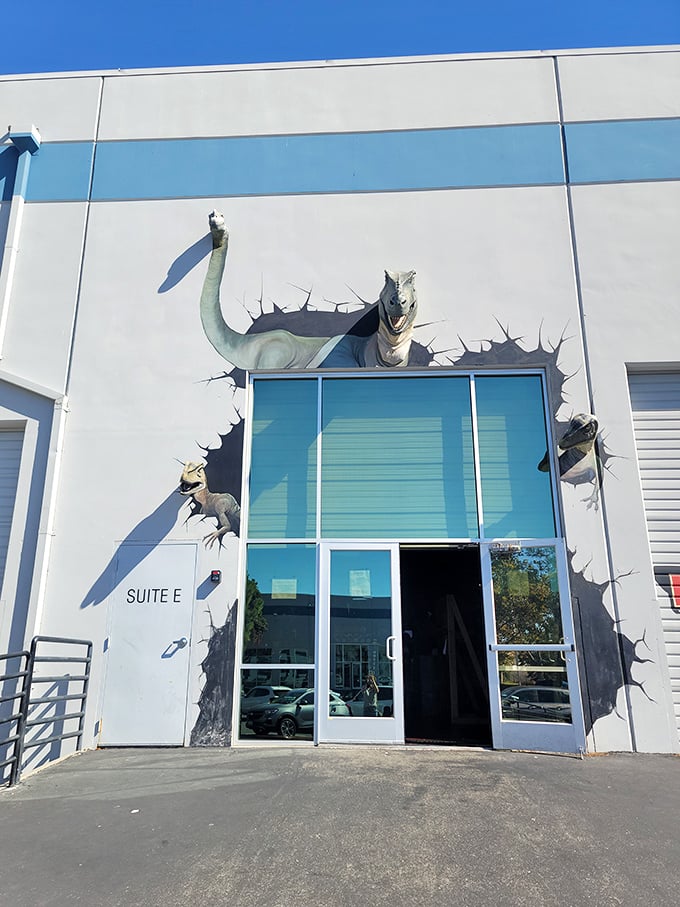 "Welcome to Jurassic Park… er, Lost Worlds Adventures!" This eye-catching entrance sets the stage for prehistoric thrills, with a dino bursting through the wall like an overeager party crasher.