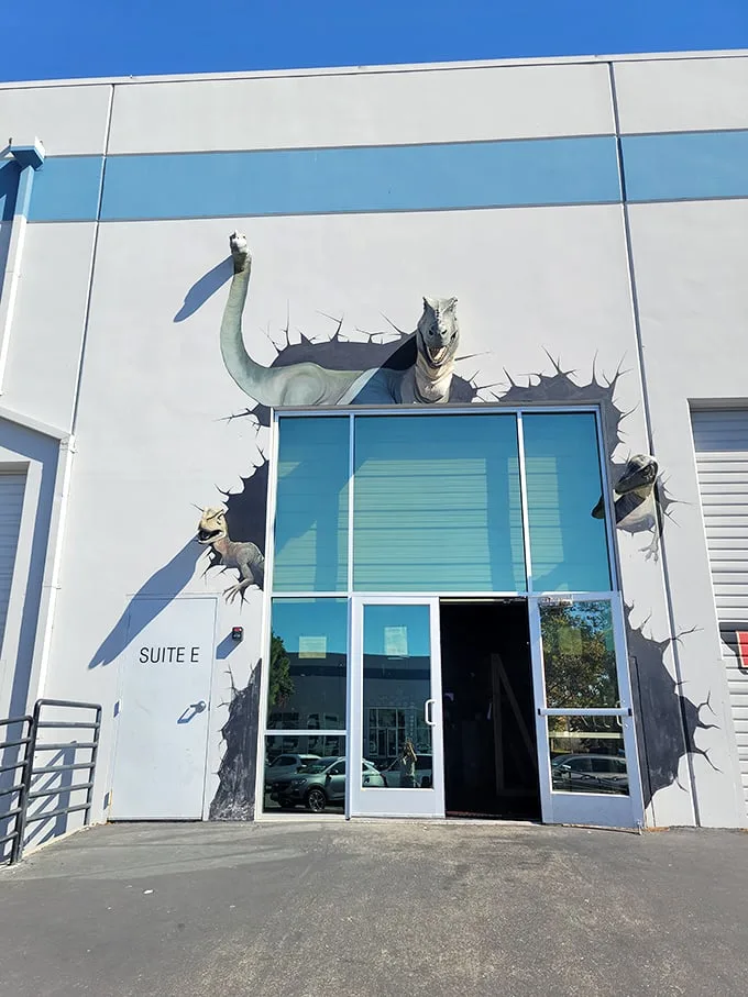 "Welcome to Jurassic Park… er, Lost Worlds Adventures!" This eye-catching entrance sets the stage for prehistoric thrills, with a dino bursting through the wall like an overeager party crasher.