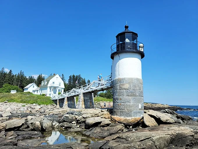 A postcard come to life! Marshall Point Lighthouse stands sentinel, its white tower and wooden walkway beckoning visitors to step into a maritime dream.