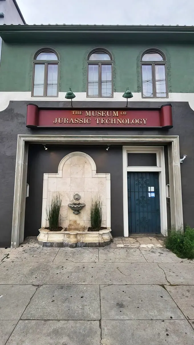 "Welcome to Wonderland!" This mint-green facade with its arched windows and quirky fountain is your portal to a world of delightful absurdity.