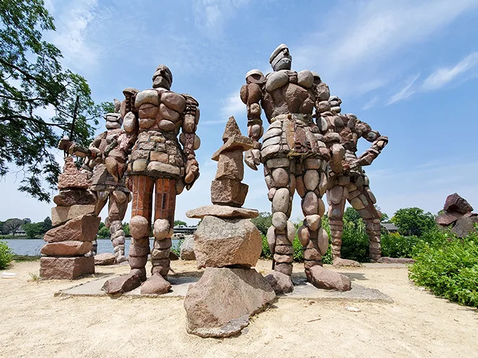 "Rock stars of a different kind! These colossal stone figures stand guard over Rockford's riverbank, striking poses that would make Michelangelo jealous."
