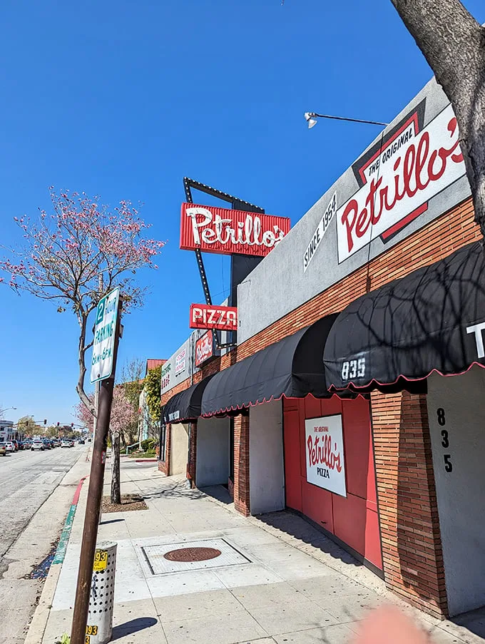Step into a time machine disguised as a pizzeria! Petrillo's sign has been beckoning pizza lovers since 1954, proving that some things never go out of style.