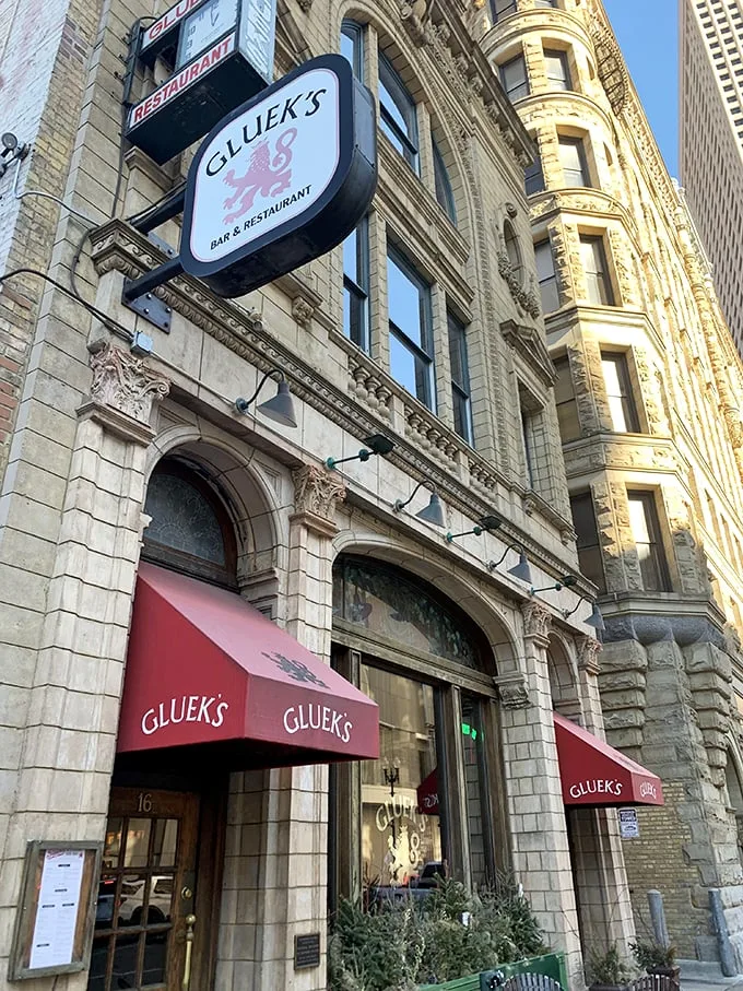Step into a time machine disguised as a beer garden! Gluek's facade glows with old-world charm, promising a night of Gemütlichkeit and frothy steins.