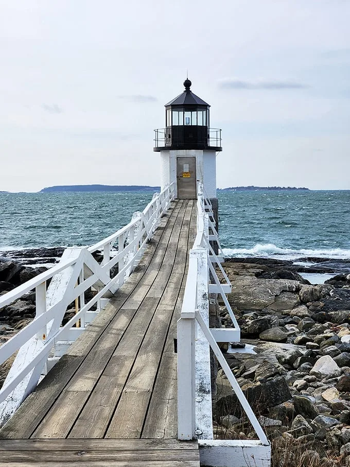 A postcard come to life! Marshall Point Lighthouse stands sentinel, its white tower and wooden walkway beckoning visitors to step into a maritime dream.