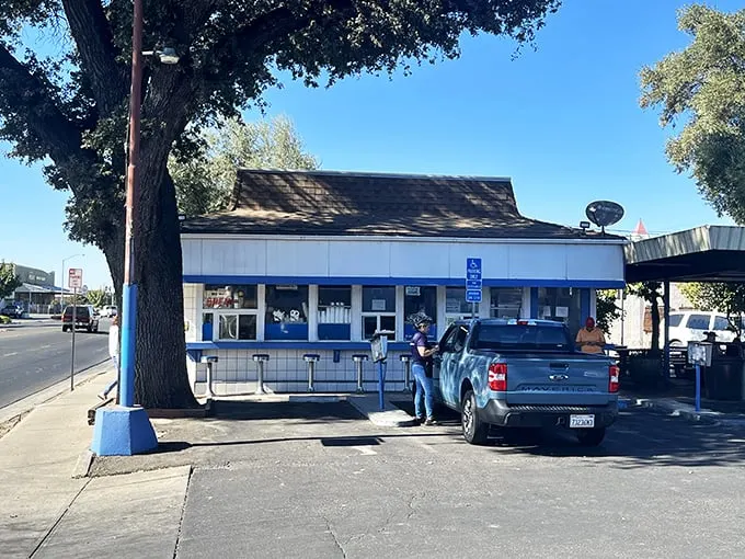 Step back in time! H & W Drive-In's classic blue-and-white exterior is like a portal to the 1950s, complete with a side of nostalgia fries.