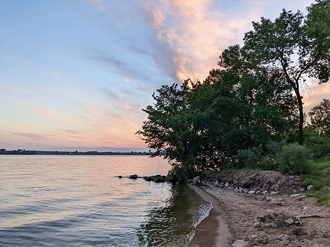 Nature's own infinity pool! The shoreline of Big Stone Lake stretches out like a mirror, reflecting the sky in a display that would make even the most jaded Instagram influencer reach for their camera.