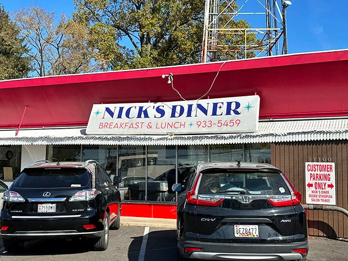 A beacon of breakfast bliss! Nick's Diner's vibrant red exterior is like a siren call to hungry souls, promising comfort food and nostalgia in equal measure.