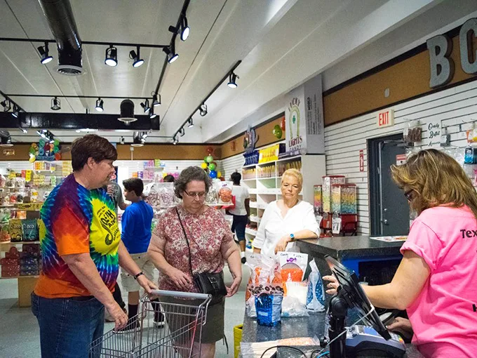 Sugar rush in progress! These shoppers are living proof that you're never too old to be a kid in a candy store.