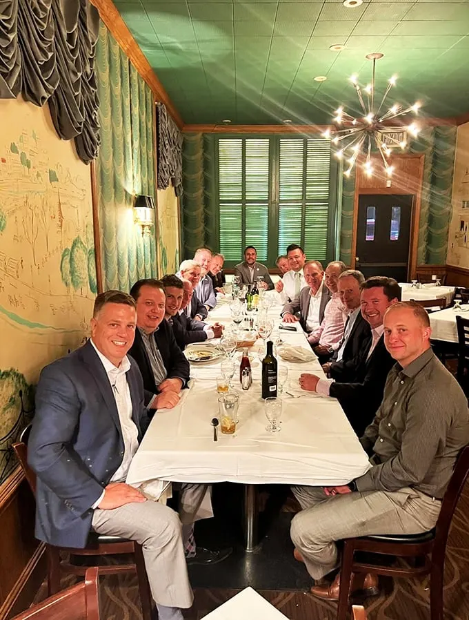 Gather 'round, meat lovers! This jovial group of diners proves that good food and great company are the secret ingredients to any memorable meal.