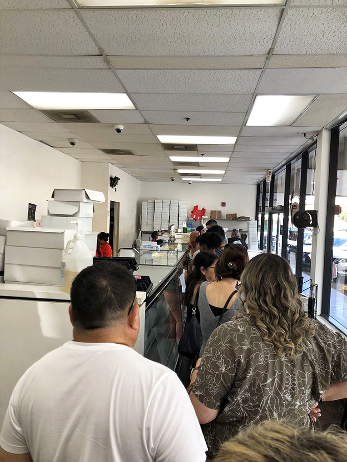 The line of anticipation! These folks know good things come to those who wait, especially when those good things are made of sugar and dough.