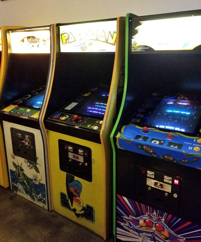 The holy trinity of classic gaming: Pac-Man, Ms. Pac-Man, and... is that Galaga? It's like the Mount Rushmore of arcades, but with more pixels.