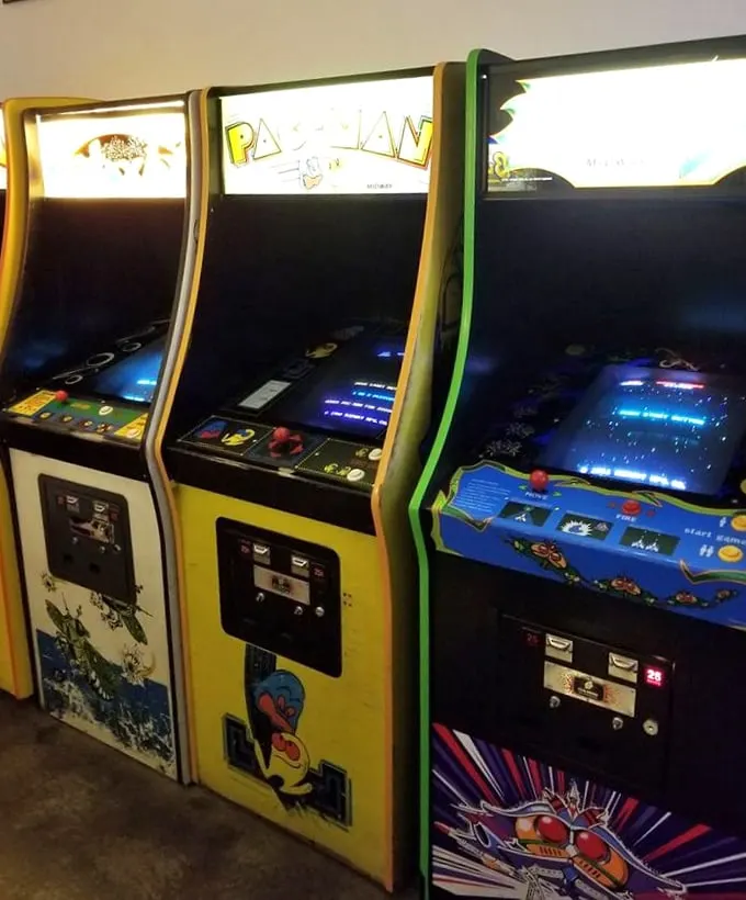 The holy trinity of classic gaming: Pac-Man, Ms. Pac-Man, and... is that Galaga? It's like the Mount Rushmore of arcades, but with more pixels.