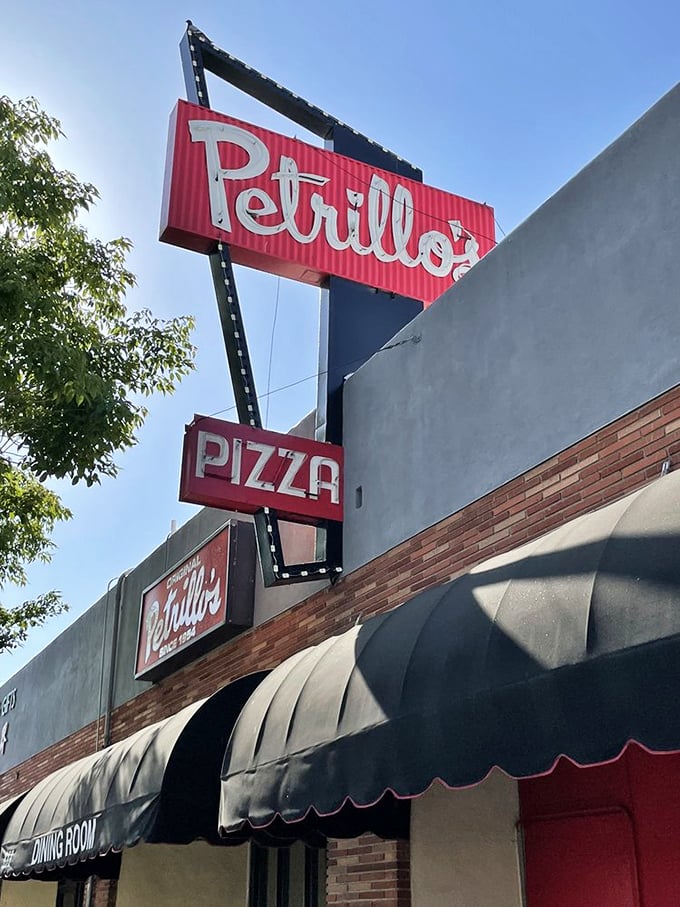 The sign says "Pizza," but what it really means is "Happiness served by the slice." Follow the neon, friends – it knows the way.