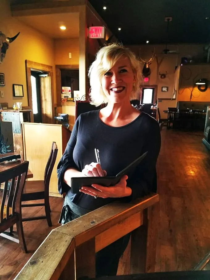 Service with a smile! This friendly face is the secret ingredient that turns a meal into a memorable experience.