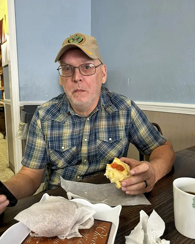A moment of pure joy captured: Man vs. Pastry. Spoiler alert – everyone's a winner in this delicious showdown.