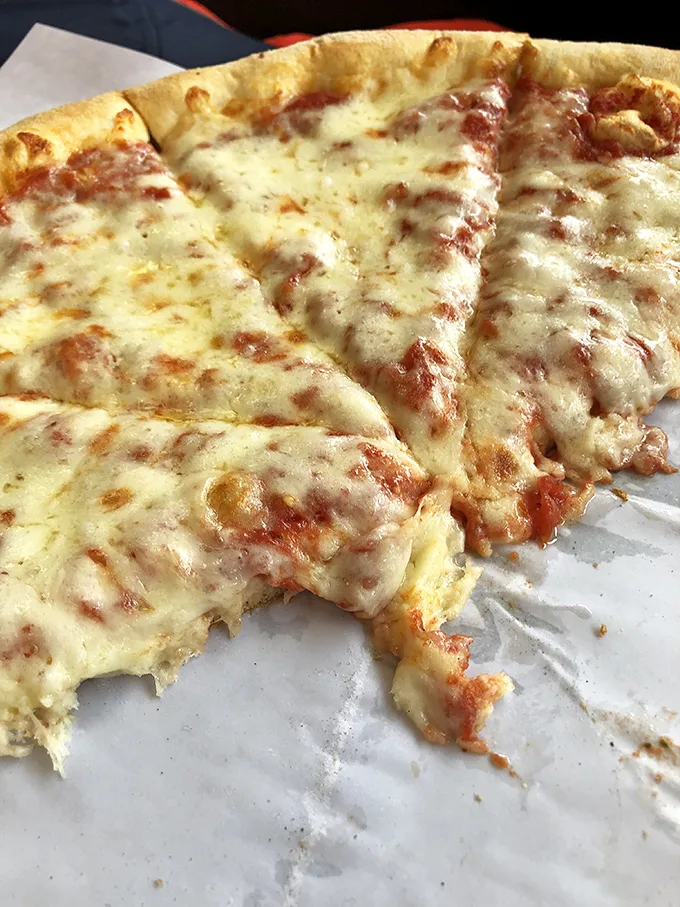 Pizza perfection! This pie is so cheesy, it could moonlight as a stand-up comedian. Get ready for some serious string action!