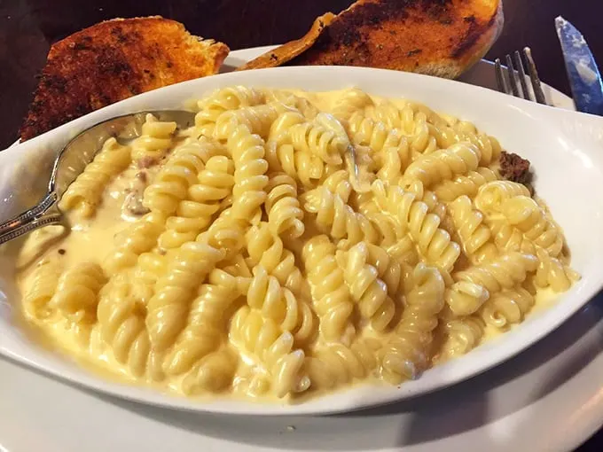 Mac and cheese that would make your childhood self green with envy. Creamy, dreamy, and cheesier than a dad joke at a family barbecue.