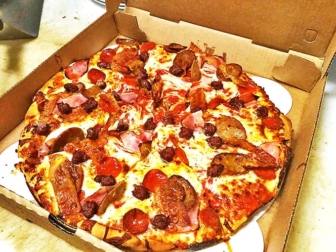 The 'kitchen sink' of pizzas – because sometimes, more is more!" This loaded pie is a testament to Pat's philosophy: why choose one topping when you can have them all?