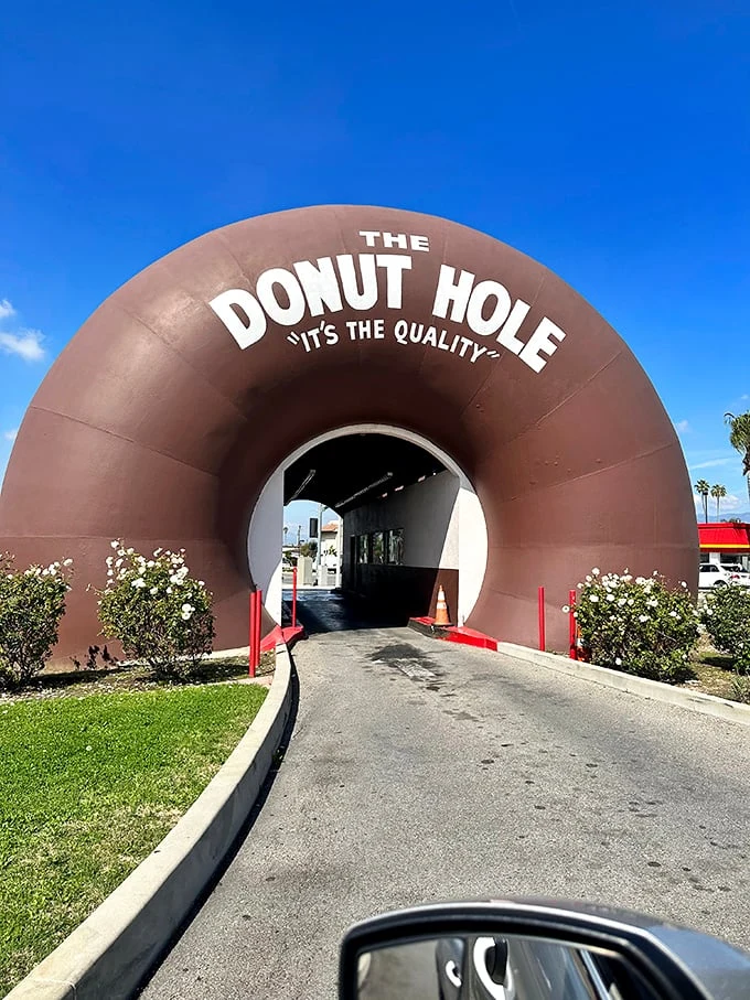Forget the yellow brick road – this chocolatey tunnel leads straight to donut nirvana. It's like Willy Wonka designed a drive-thru!