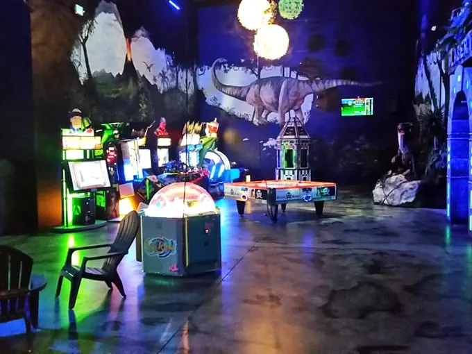 Neon dreams and arcade screams! This dimly lit wonderland is where modern tech meets Mesozoic magic, creating a gamer's paradise with a prehistoric twist.