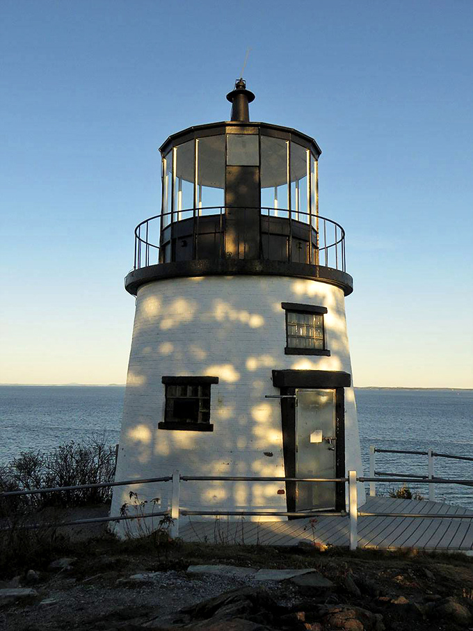 Sunlight plays peek-a-boo with the lighthouse, creating a dazzling light show. Mother Nature's own disco ball, Maine style!