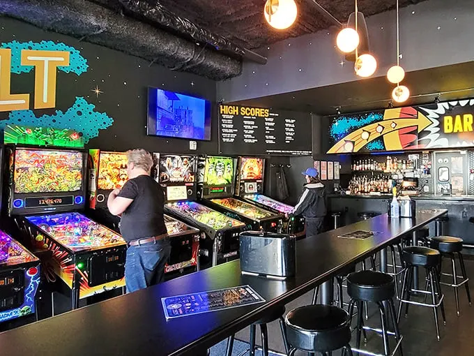 Step inside and prepare for sensory overload! The cacophony of pinball machines and clinking glasses creates a symphony of pure joy.