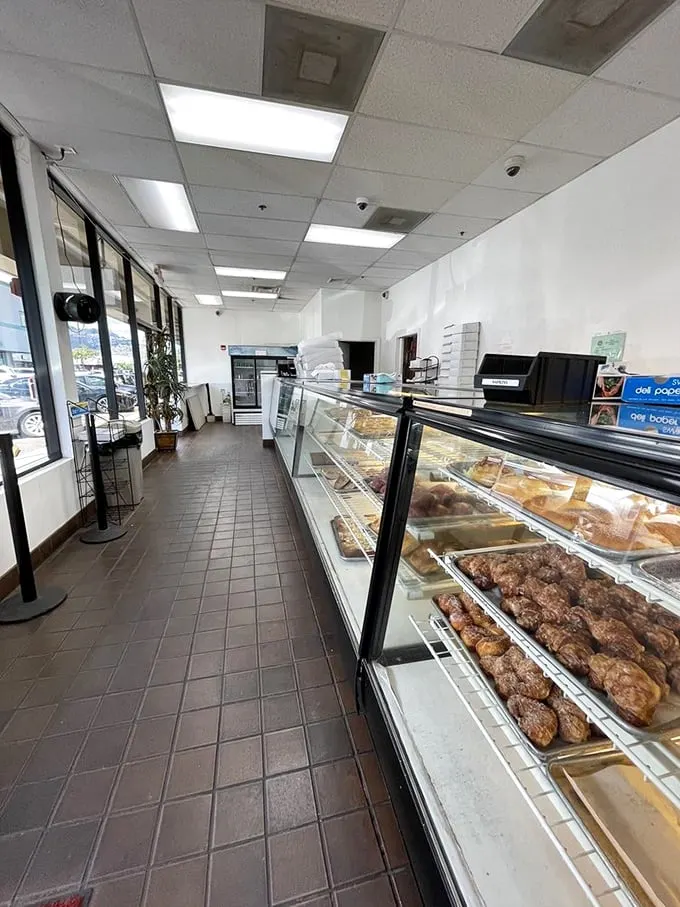 Step into a time machine of taste! This no-frills interior showcases a dazzling array of pastries that'll transport you straight to flavor town.