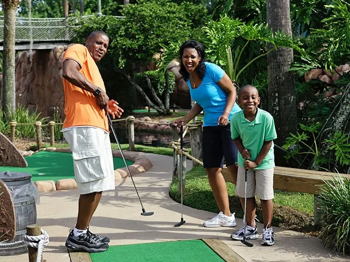 Family fun that's anything but par for the course! These smiles are brighter than the Florida sunshine – and probably more consistent than Dad's swing.