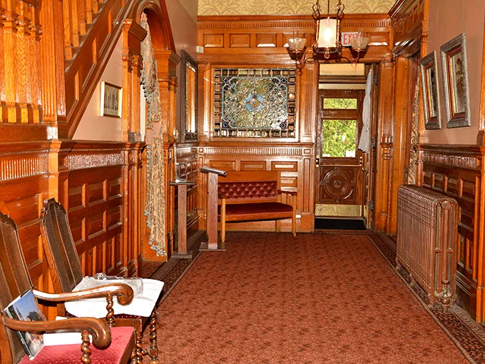 Step into a time warp! This entryway screams 'Gilded Age glamour' louder than a steam locomotive whistle. Woodwork so intricate, it puts modern IKEA assembly to shame.