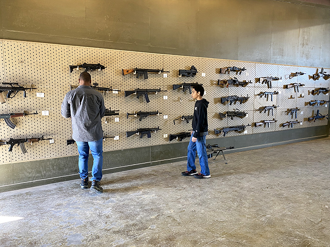"More firepower than a Texas BBQ cookoff!" An impressive array of firearms lines the wall, each with a story to tell.