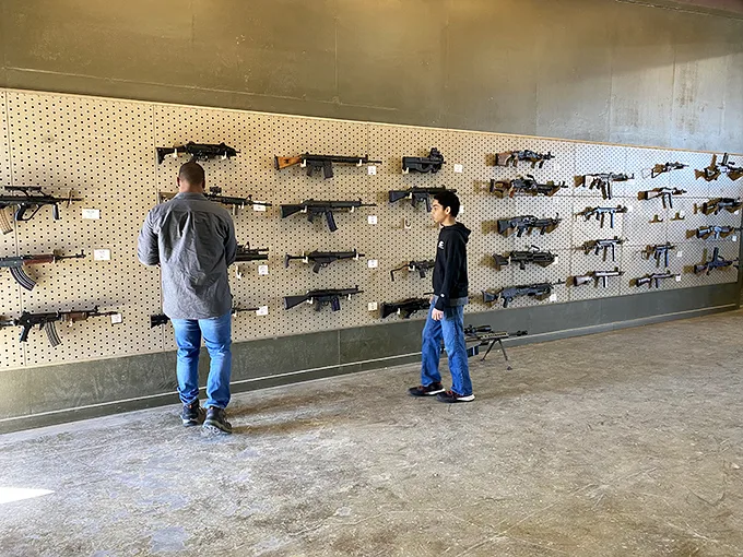 "More firepower than a Texas BBQ cookoff!" An impressive array of firearms lines the wall, each with a story to tell.
