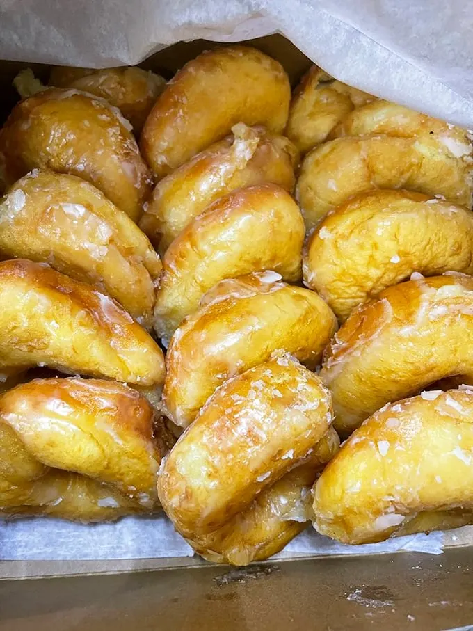 Golden orbs of joy! These glazed donuts shine brighter than a Hawaiian sunset, promising a taste of paradise in every bite.