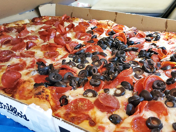 Pepperoni and olives locked in an eternal dance atop a sea of molten cheese. It's pizza perfection, plain and simple.