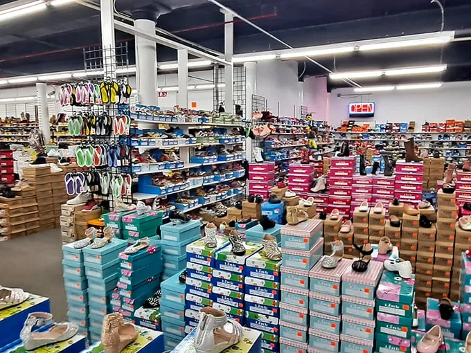If Imelda Marcos had a dream, this would be it. Rows upon rows of footwear await their Cinderella moment. Who knew salvation could come in the form of discount shoes?