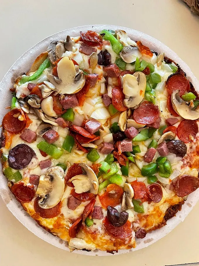 The "Alex Special" - a pizza so loaded, it's like the entire produce aisle and deli counter decided to party on your plate.