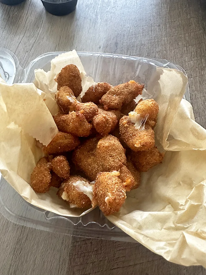Holy cow, these cheese curds! Crispy on the outside, gooey on the inside – they're like little nuggets of dairy gold.
