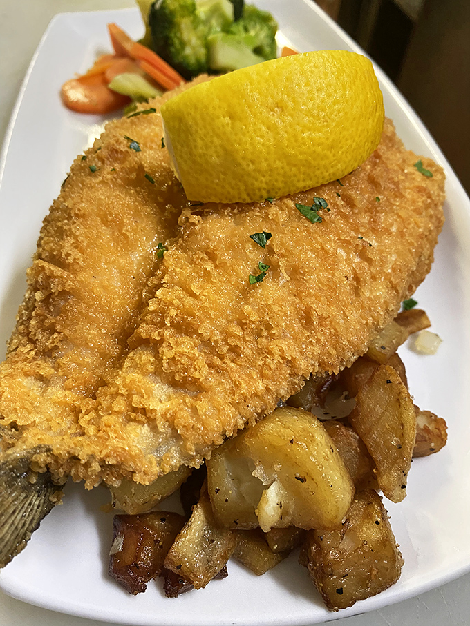 Golden-crusted fish that would make Poseidon himself jealous. Perched atop a bed of crispy potatoes, it's a seafood lover's dream come true.