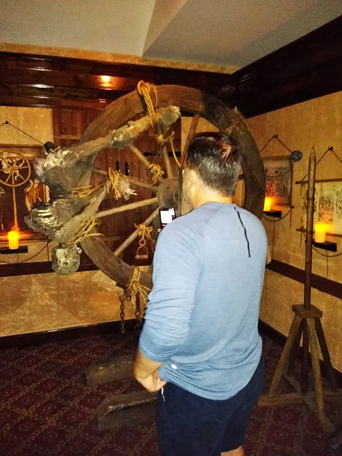 "Does this make my arms look long?" One visitor gets up close and personal with history's most infamous stretching machine.