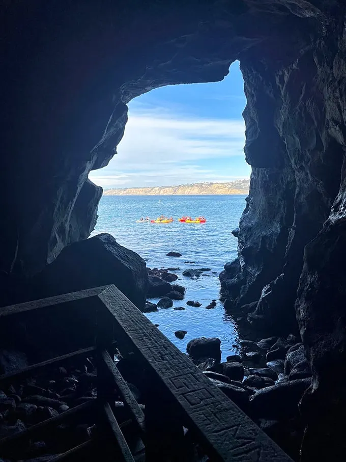 Kayakers paddling by, probably wondering why we're peeking out of a rock. It's like being in a real-life game of Peek-a-Boo with the Pacific.