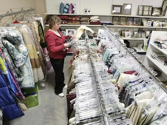 Treasure hunting is serious business! A dedicated shopper meticulously combs through racks, proving that patience pays off in the thrift store game.
