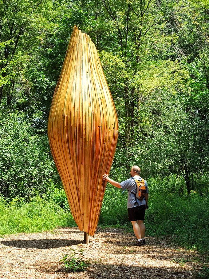 "Does this sculpture make me look tall?" This wooden wonder towers over visitors, inviting them to reach for the sky – literally.