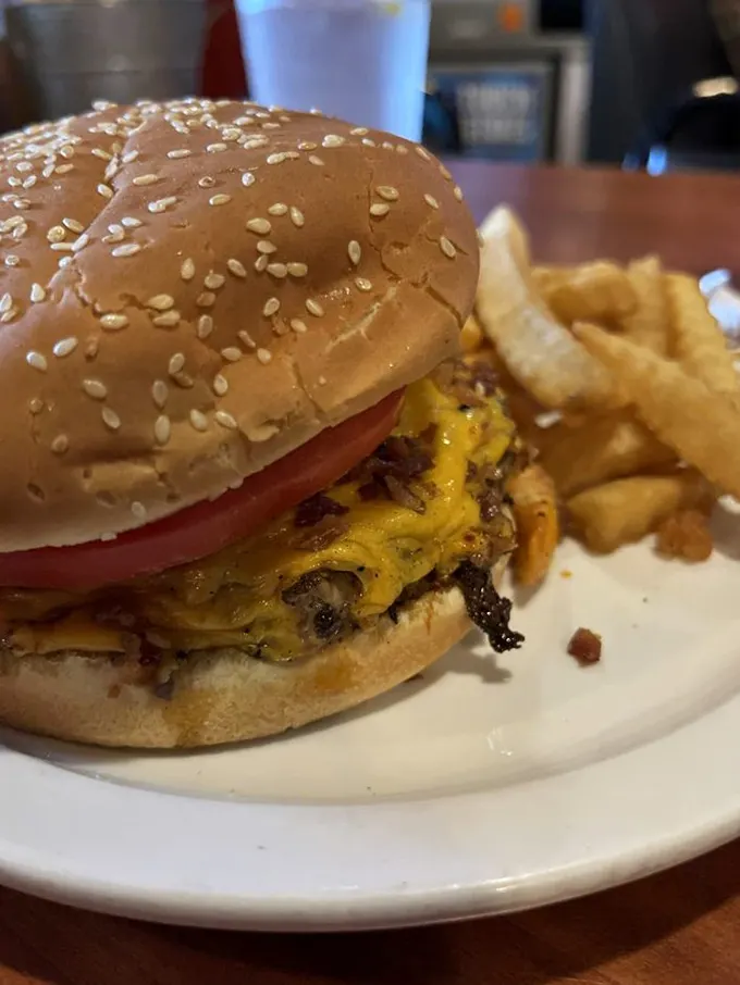 This isn't just a cheeseburger; it's a tower of beefy perfection that'll make your jaw drop… right before you take a big bite.