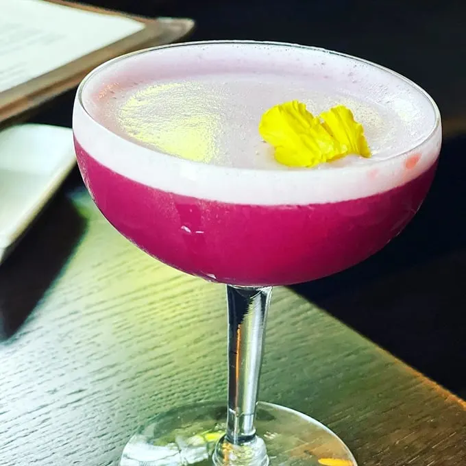 Purple Rain in a glass? Prince would approve. This cocktail is so pretty, you almost don't want to drink it. Almost.