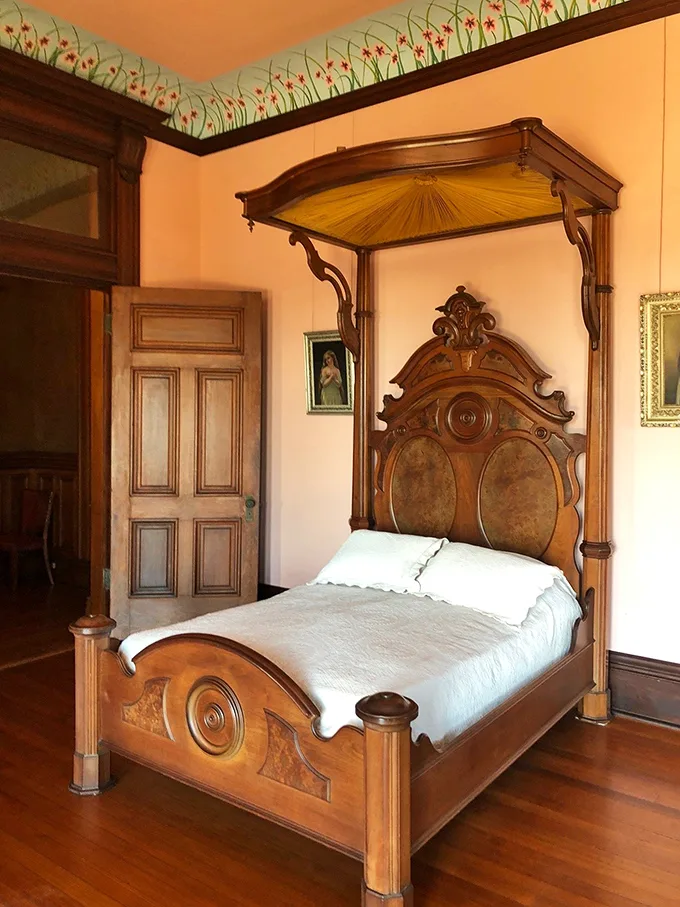 "Nap like royalty, dream like a Texan." This bedroom's canopied bed and floral touches blend regal comfort with a touch of prairie charm.