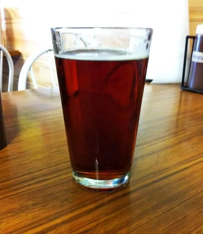 Amber waves of… beer? This frosty pint is the perfect companion for your barbecue journey, like a loyal sidekick in a meaty adventure.