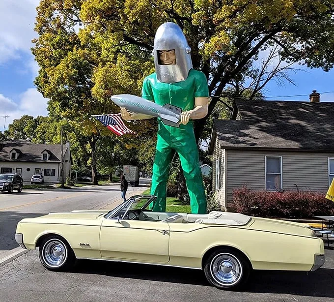 Classic car meets cosmic colossus – it's like "American Graffiti" got a reboot from Stanley Kubrick. Now that's what I call a space race!